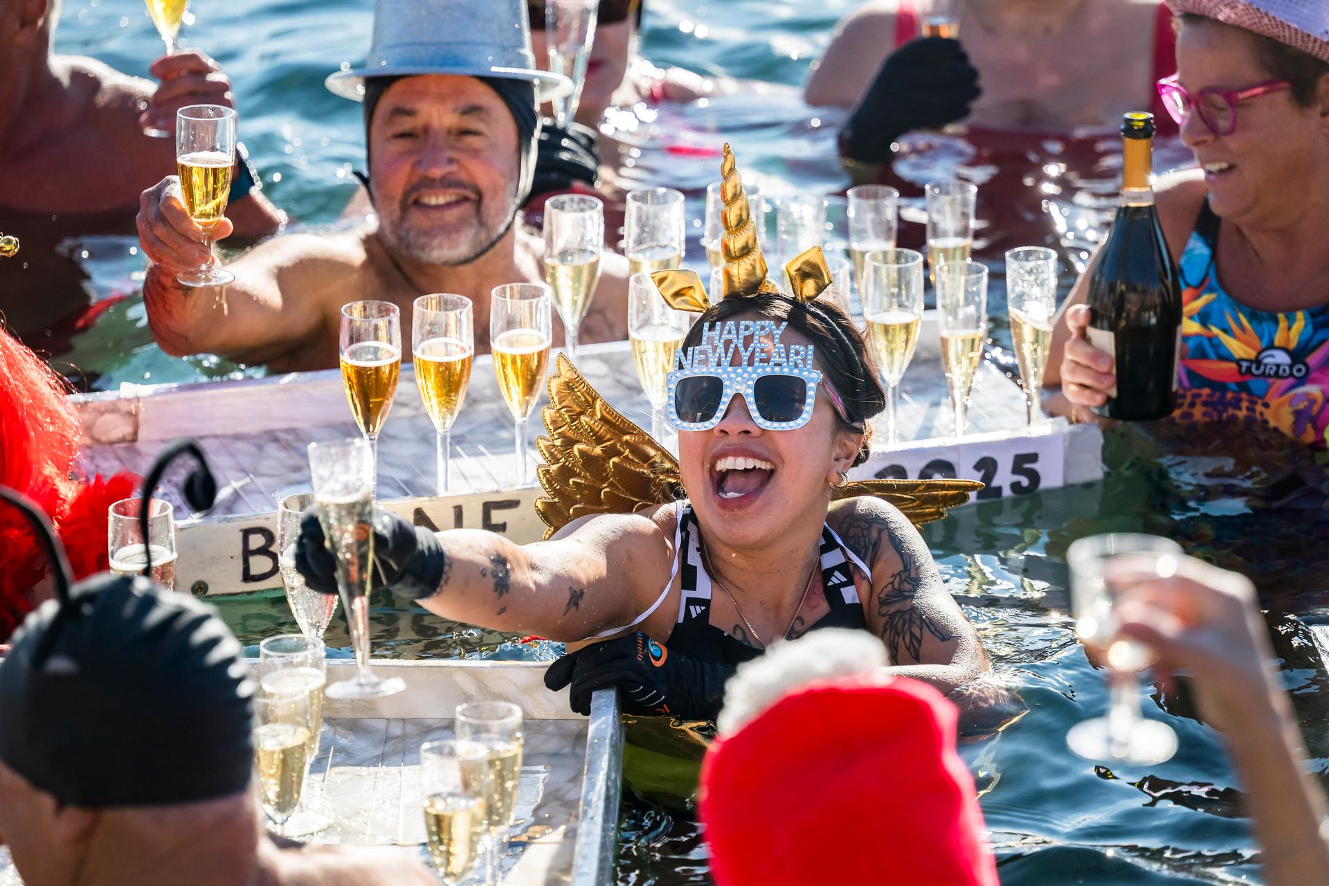 Day in Photos: New Year Swim, Fireworks Attack, and Tar Barrel Festival ...
